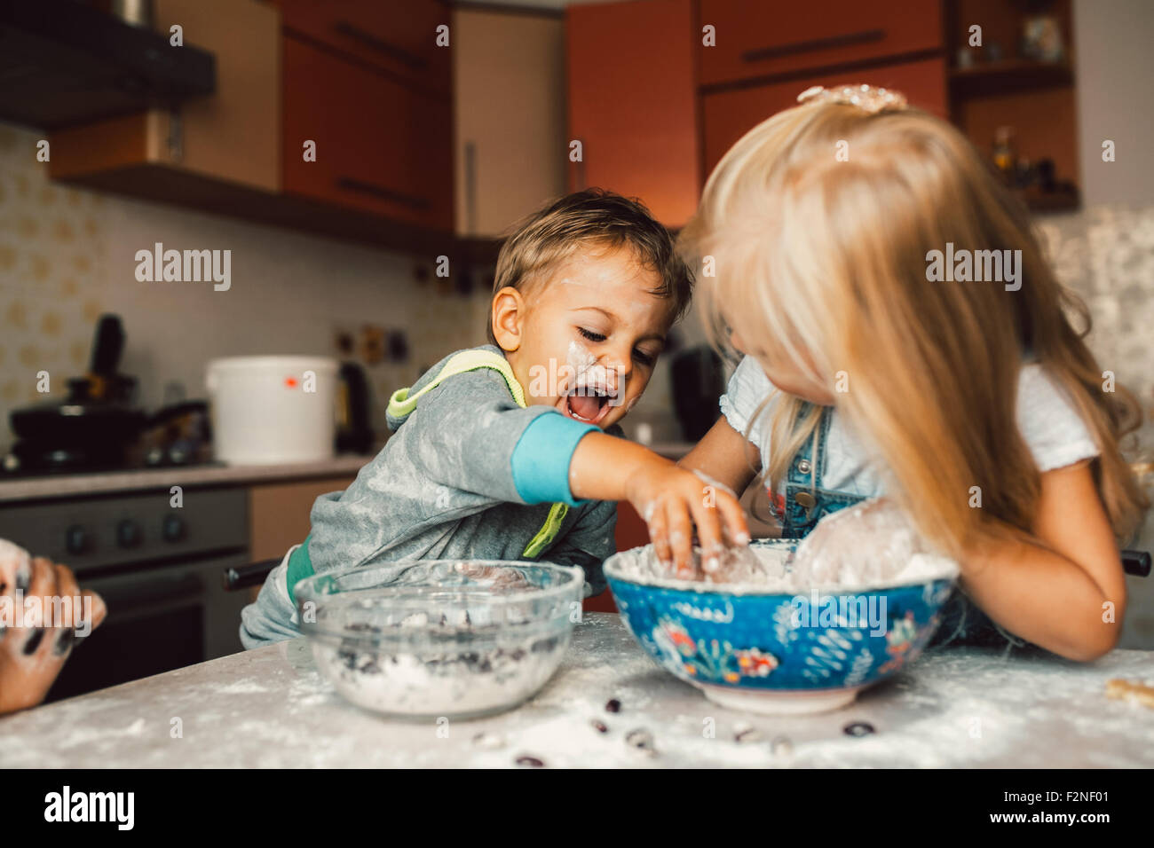 Kids is playing with flour Stock Photo - Alamy