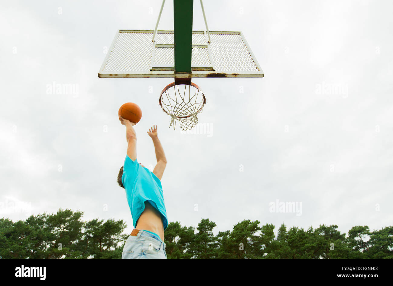 young man playing basketball outdoors Stock Photo - Alamy