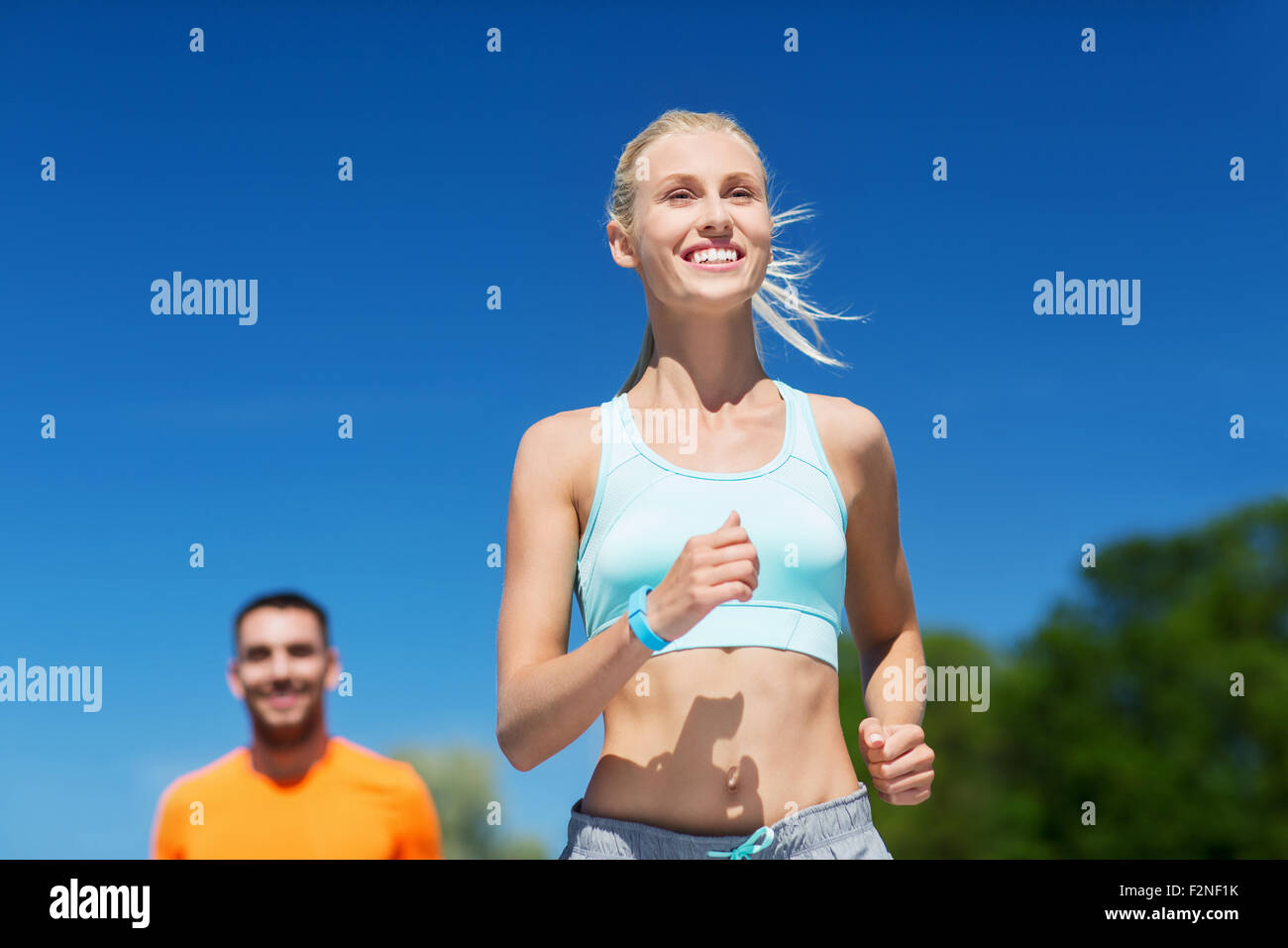 smiling couple running outdoors Stock Photo - Alamy
