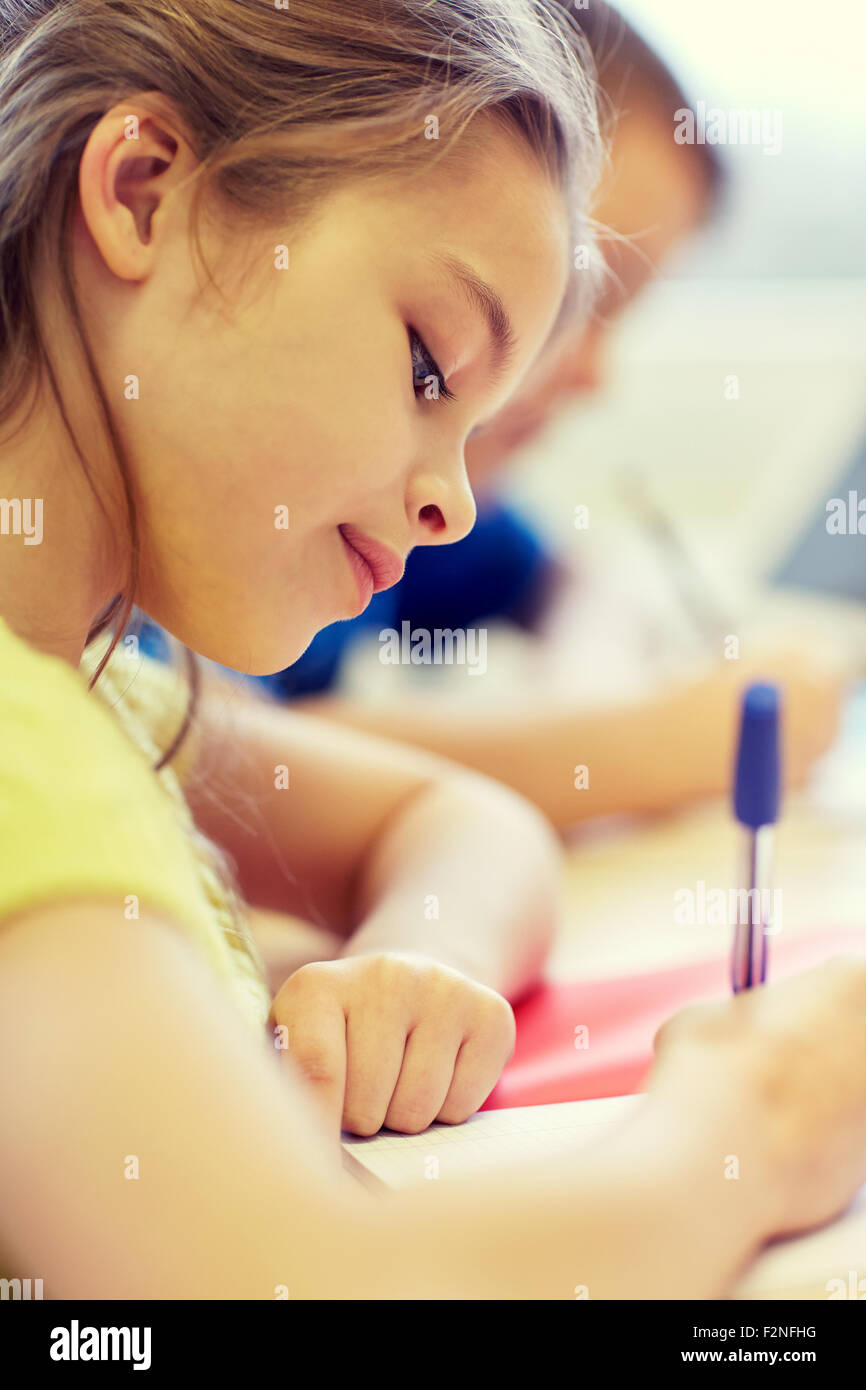 close up of school kids writing test in classroom Stock Photo - Alamy