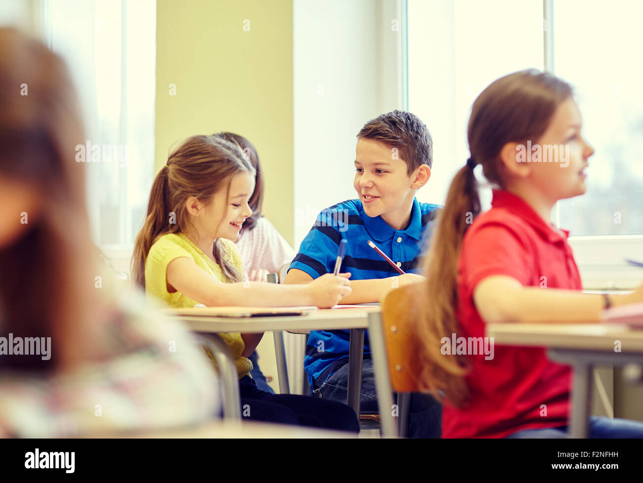 group of school kids writing test in classroom Stock Photo - Alamy