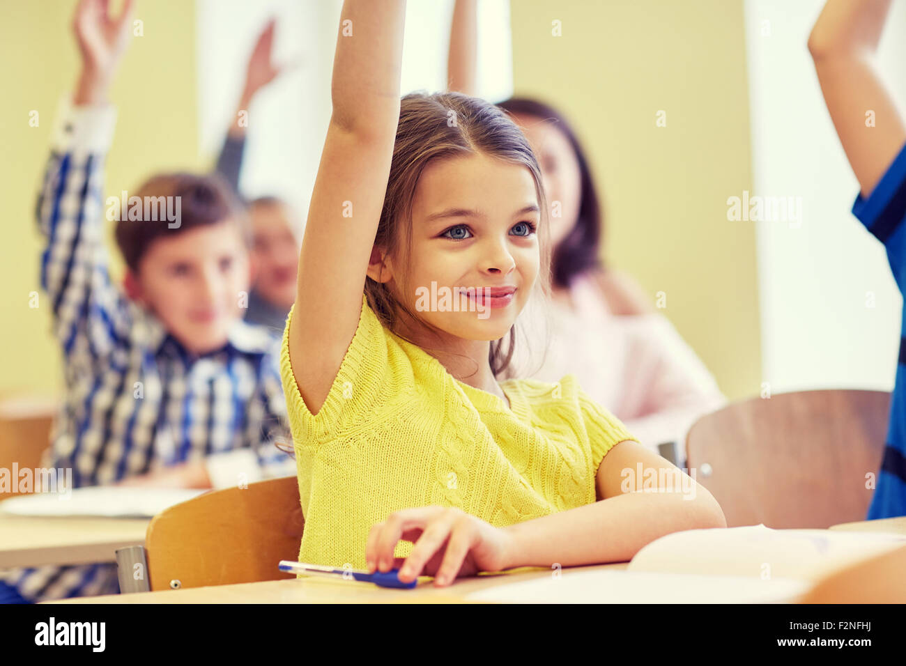 group of school kids with notebooks in classroom Stock Photo - Alamy