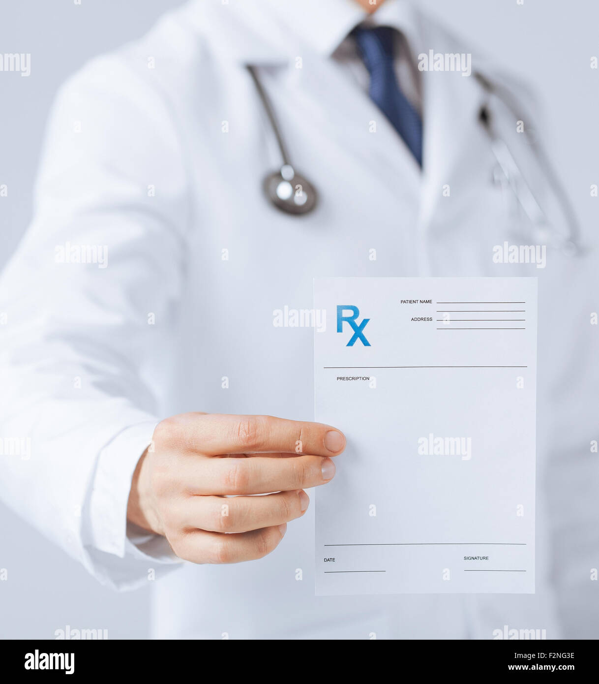 male doctor holding rx paper in hand Stock Photo - Alamy