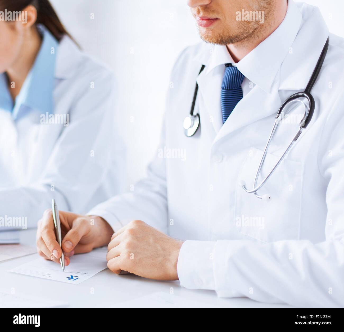 doctor and nurse writing prescription paper Stock Photo - Alamy