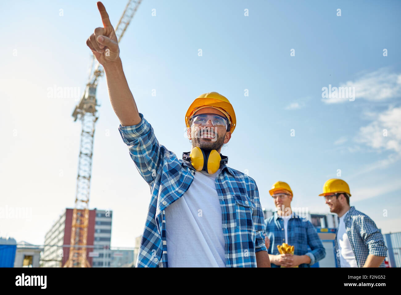 builders pointing finger aside on construction Stock Photo - Alamy