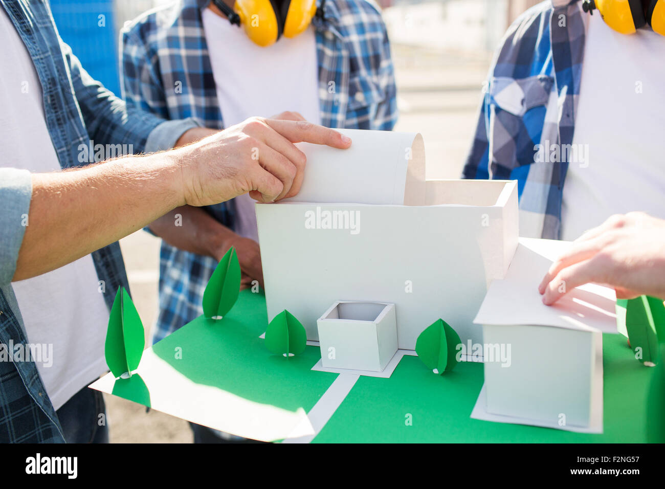 close up of builders with paper house model Stock Photo - Alamy