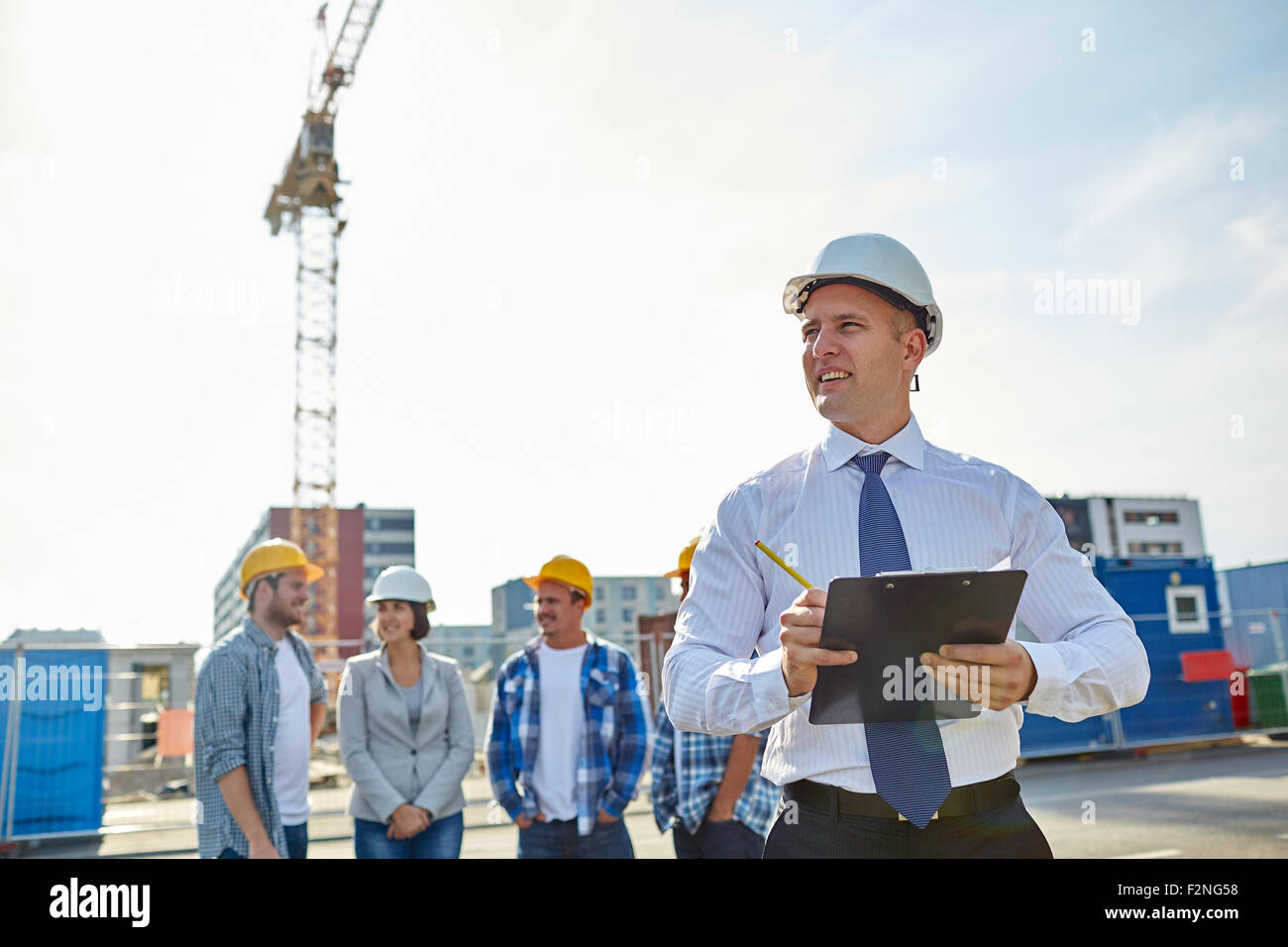 happy builders and architect at construction site Stock Photo - Alamy