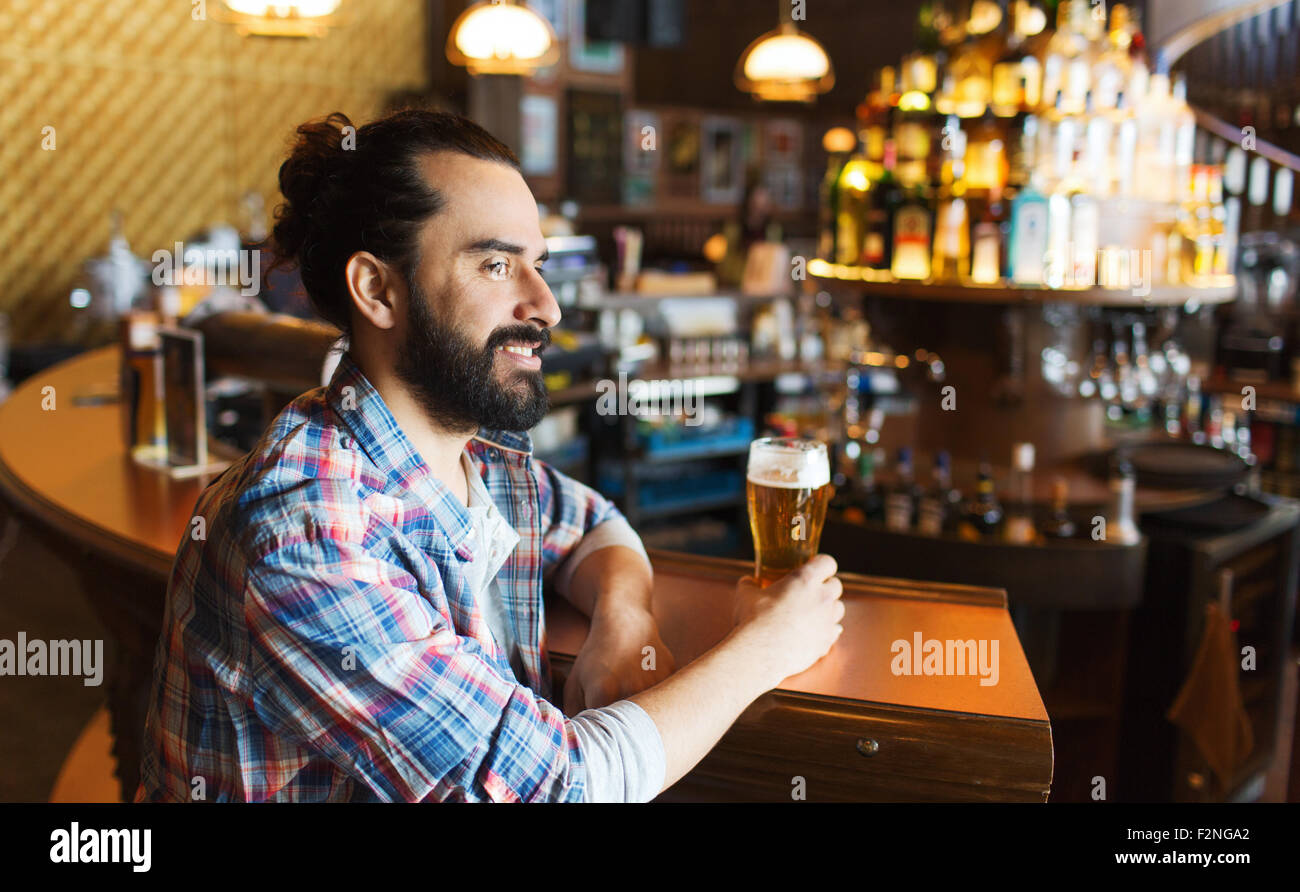happy man drinking beer at bar or pub Stock Photo - Alamy