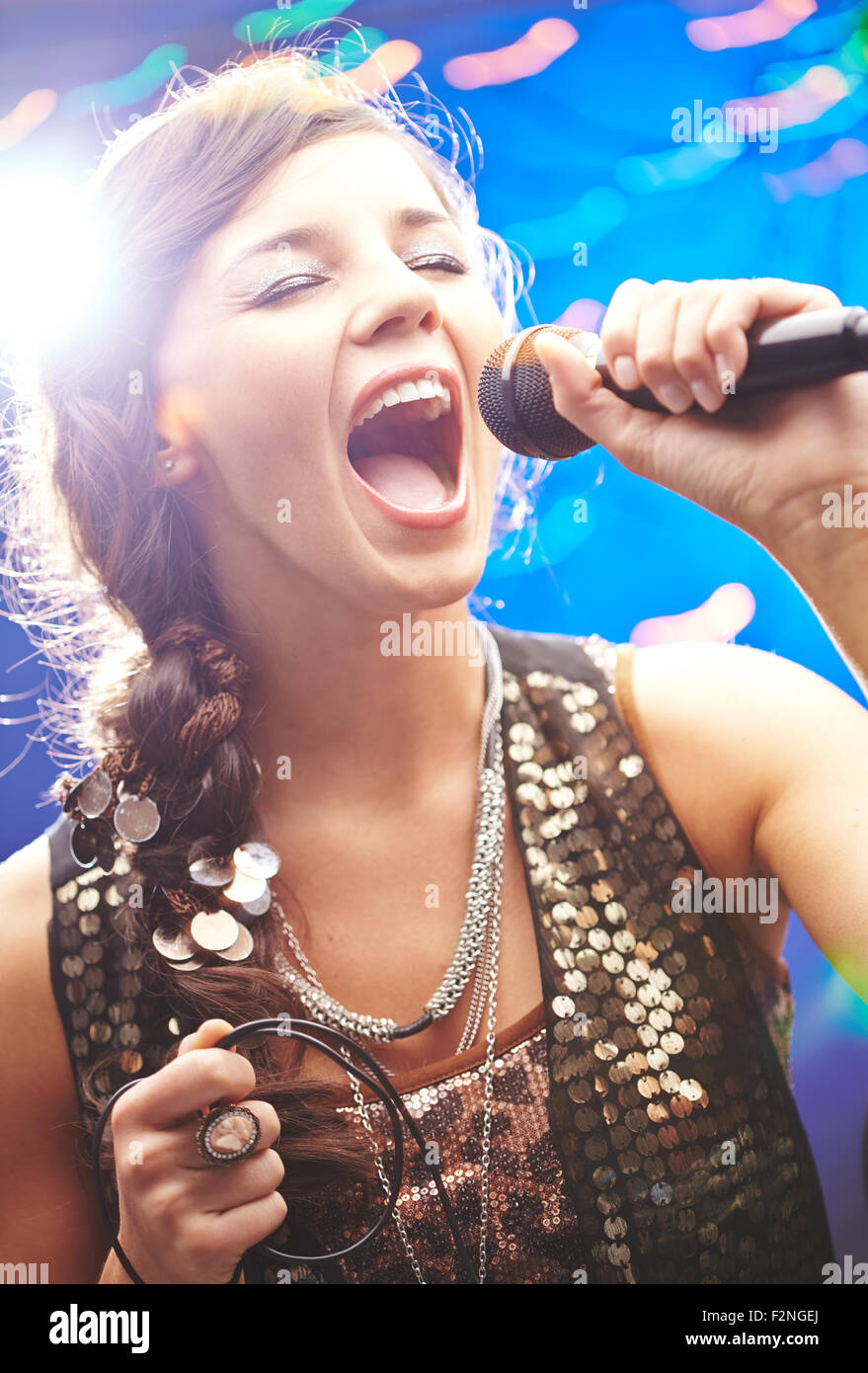 Glamorous girl singing emotional song Stock Photo - Alamy