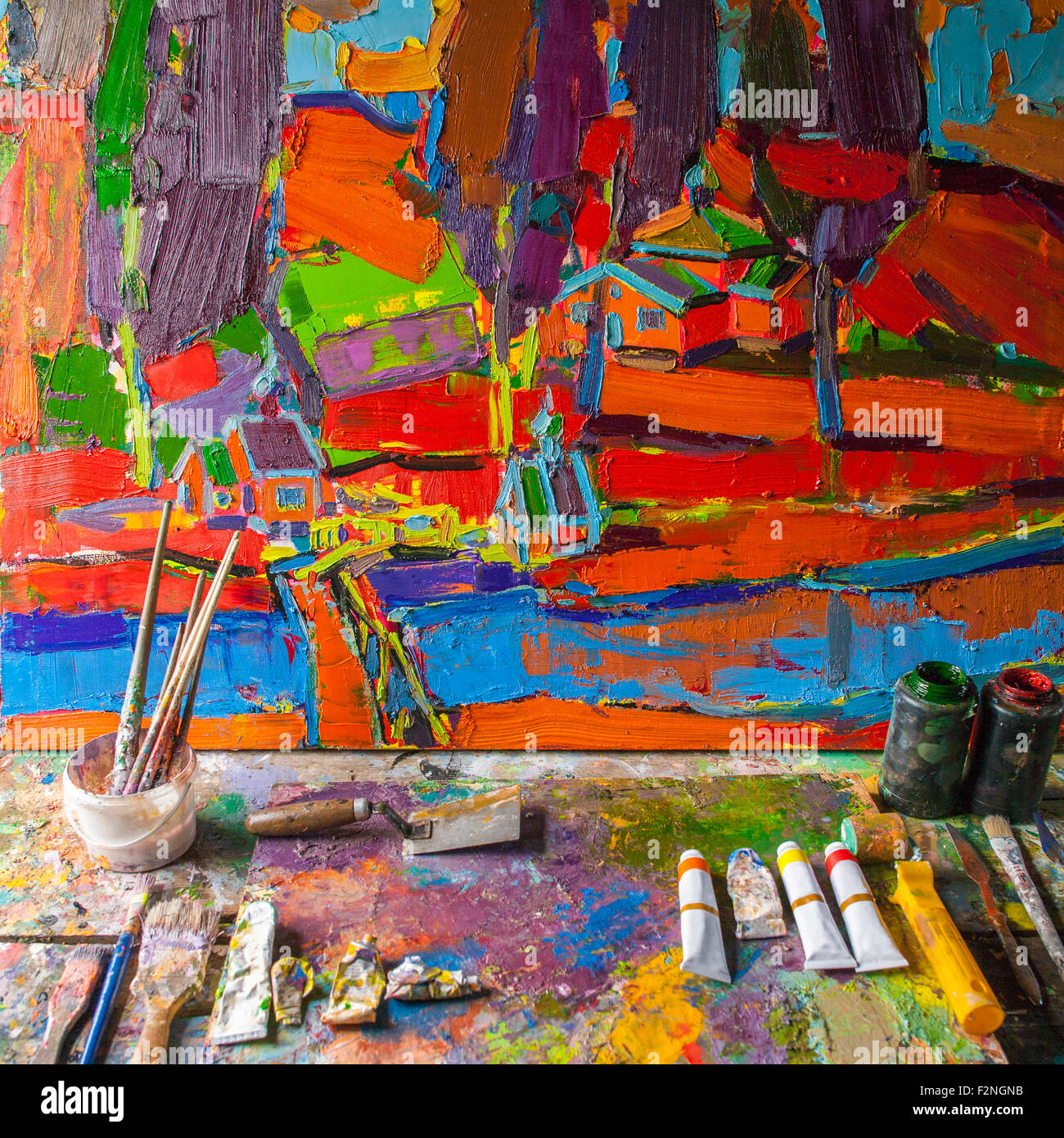 Painting on easel with paint and paintbrushes Stock Photo - Alamy