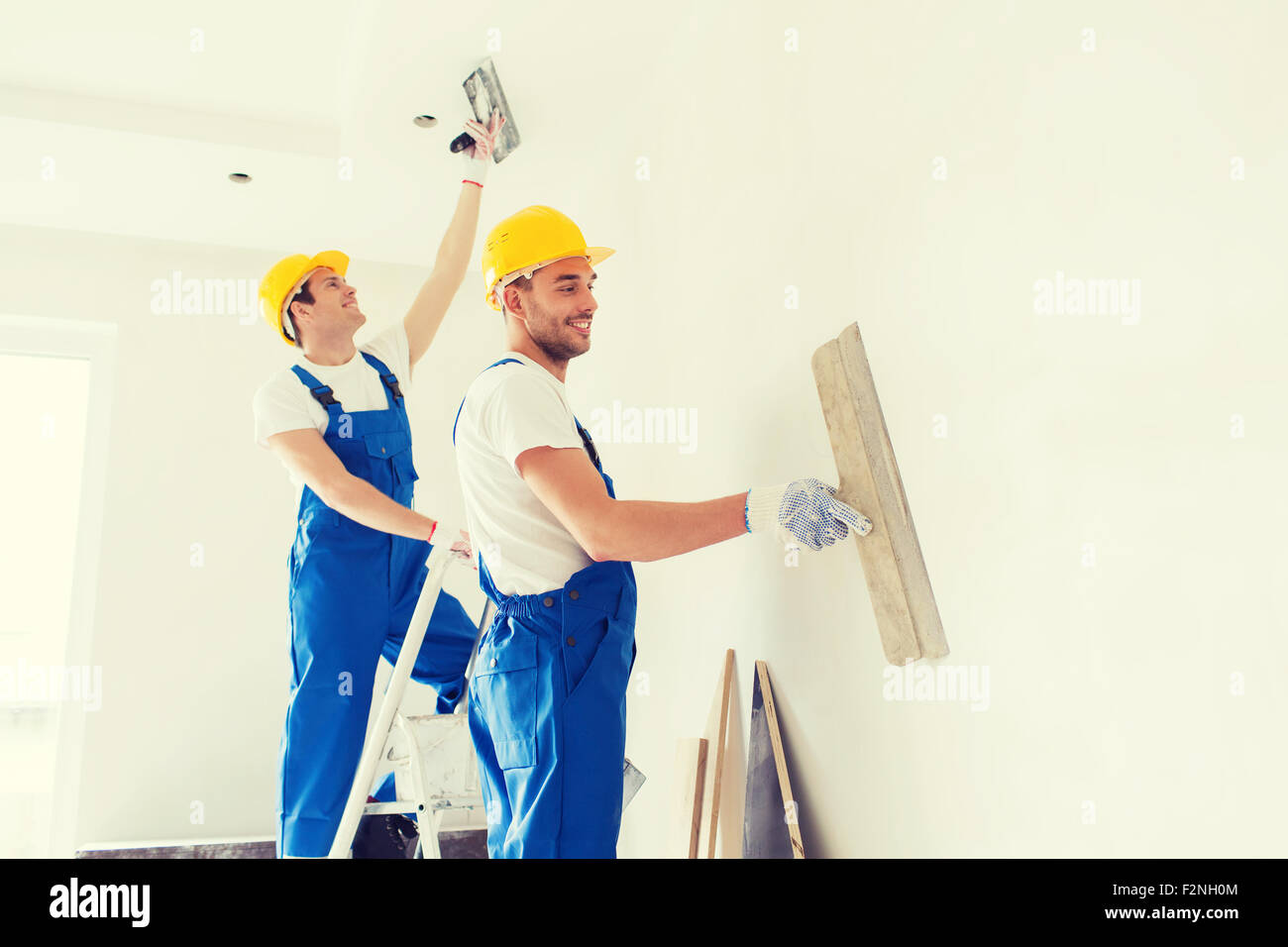group of builders with tools indoors Stock Photo - Alamy
