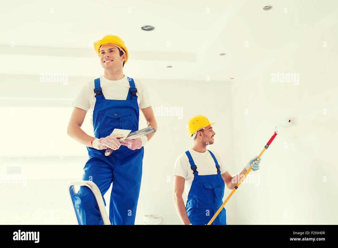 group of builders with tools indoors Stock Photo - Alamy