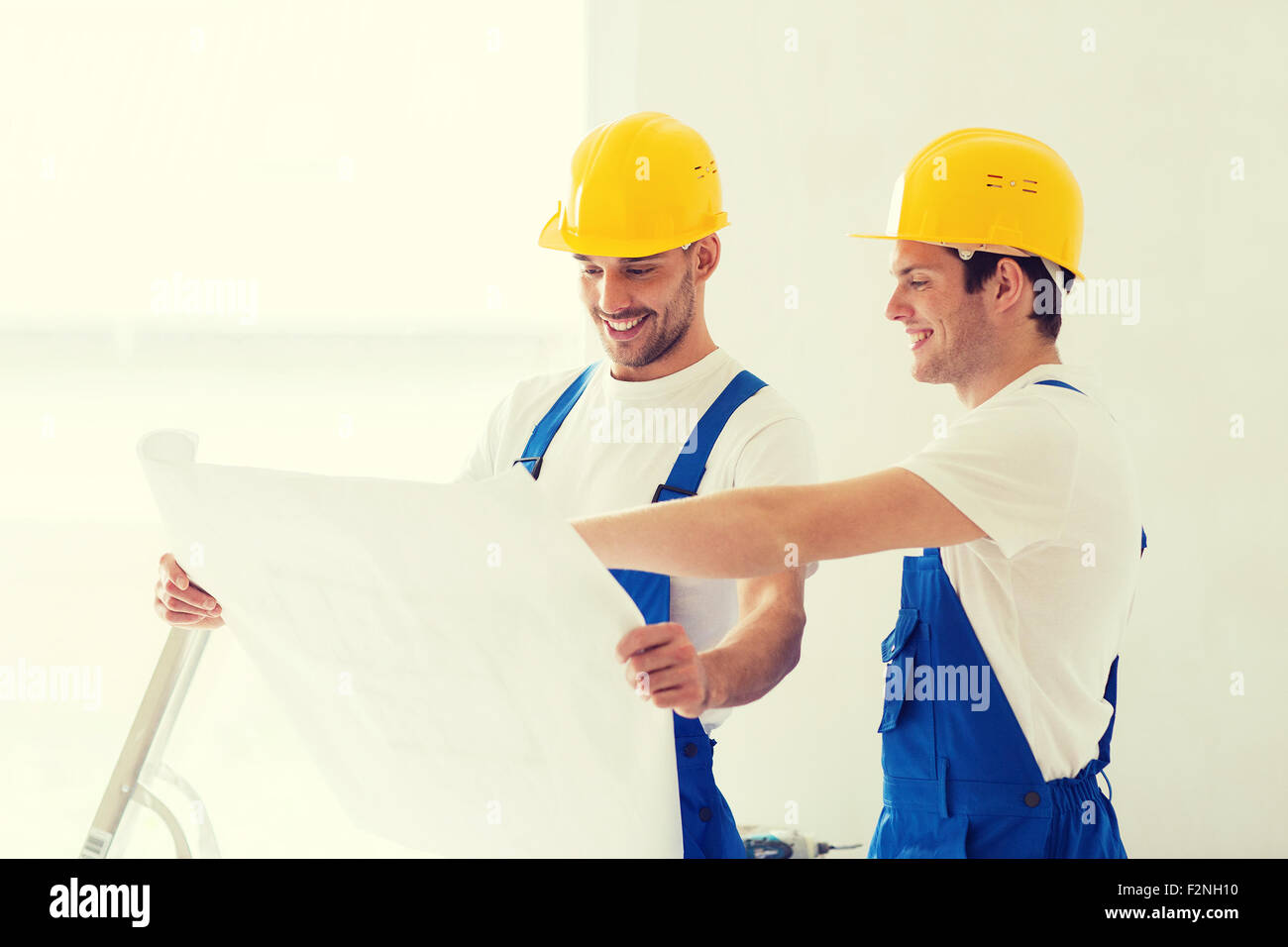 group of builders with blueprint Stock Photo - Alamy