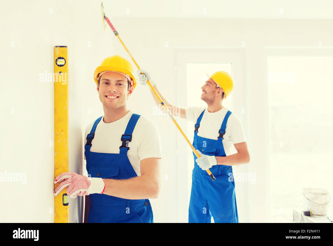 group of builders with tools indoors Stock Photo - Alamy