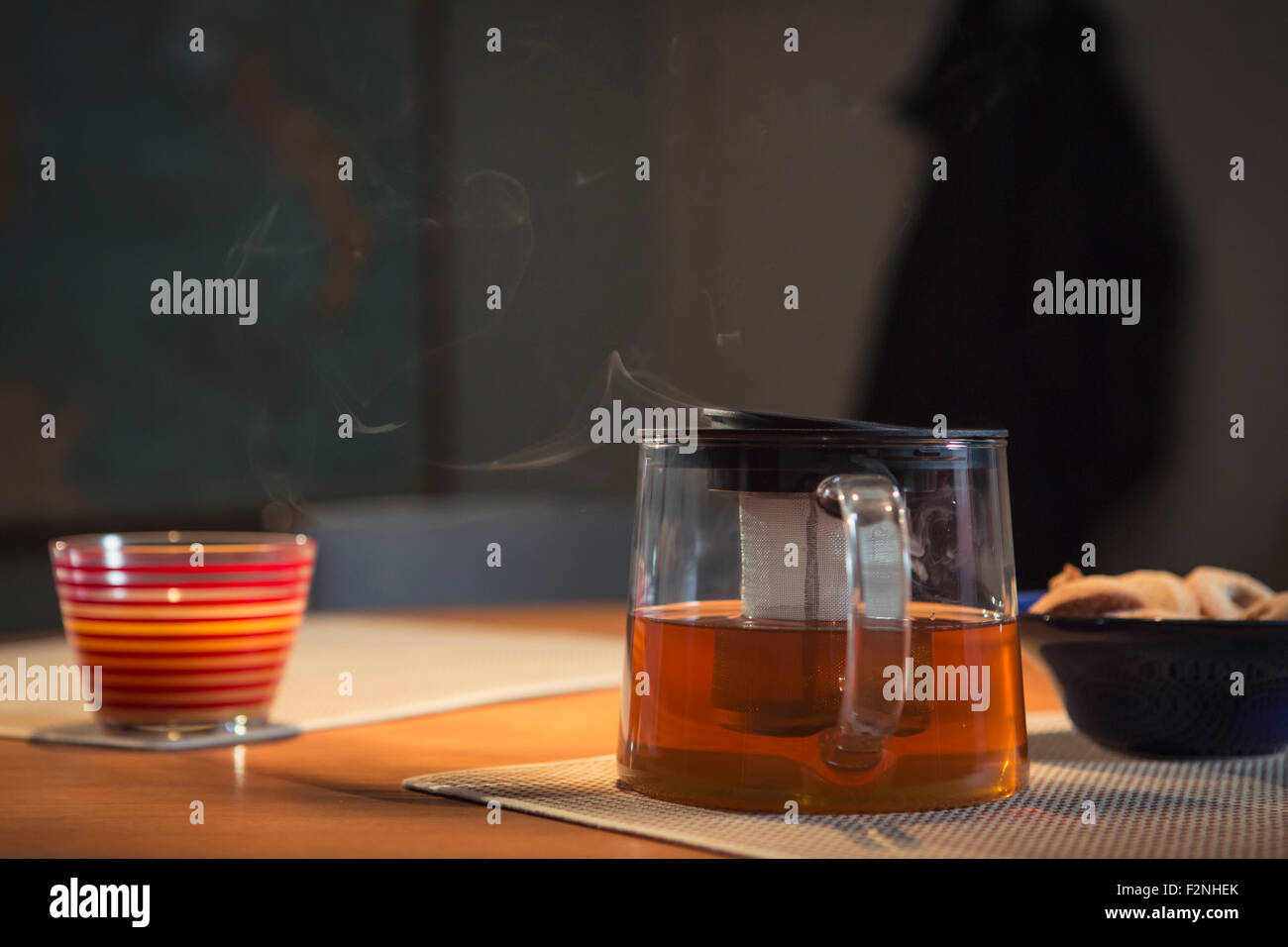 Steaming pot of tea on table Stock Photo - Alamy