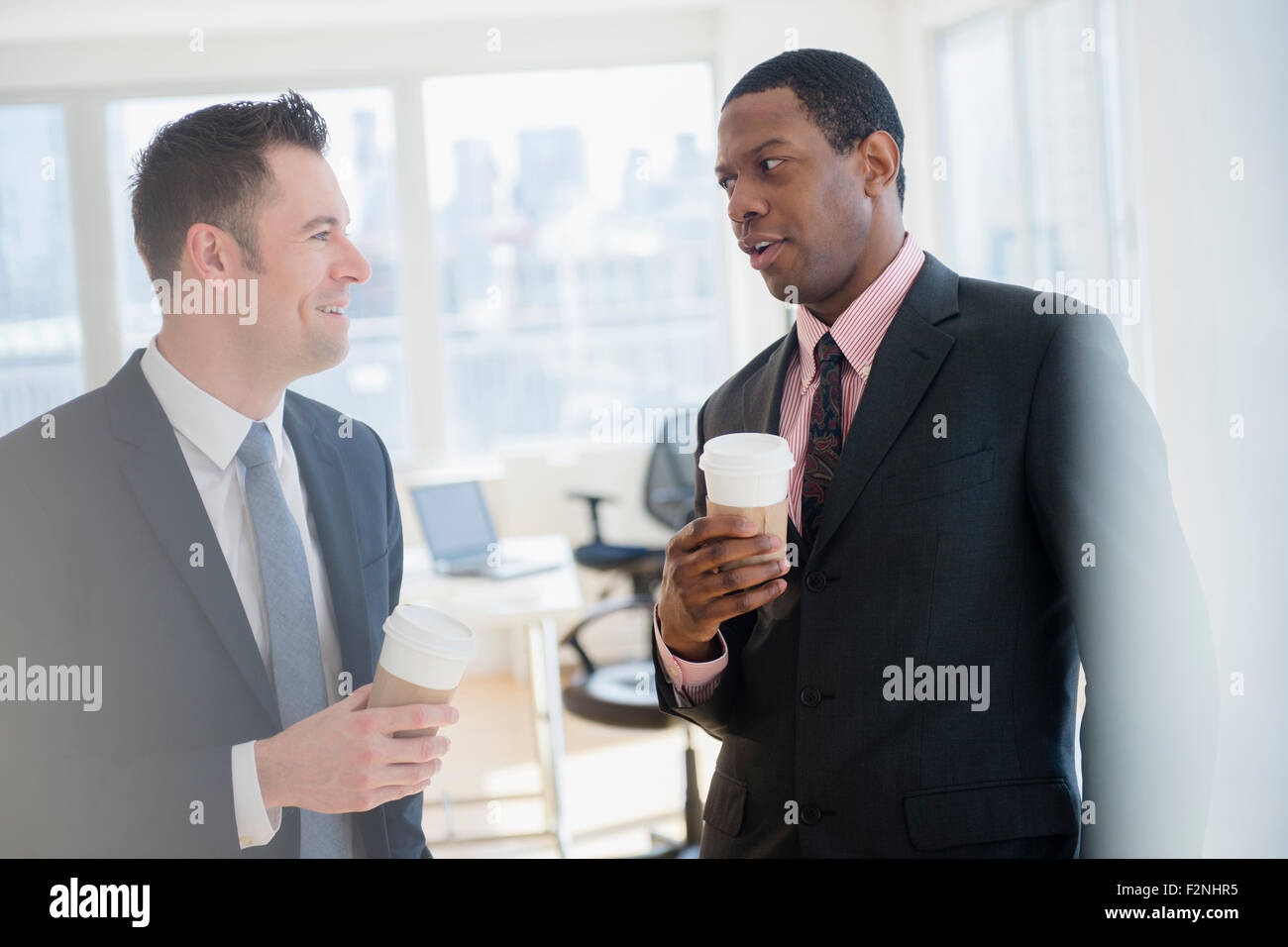 Businessmen drinking coffee in office Stock Photo - Alamy