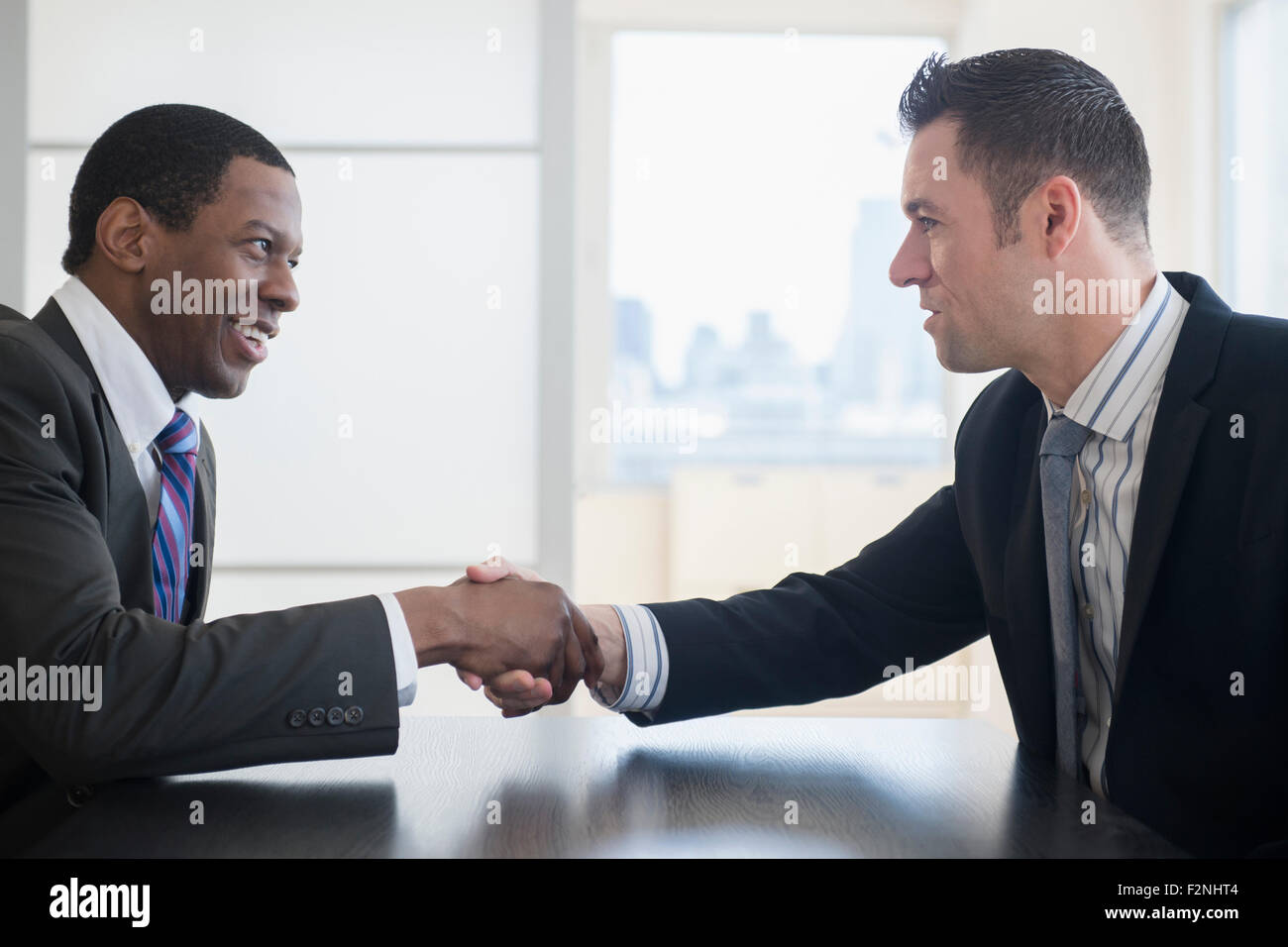 Both in profile shaking hands hi-res stock photography and images - Alamy