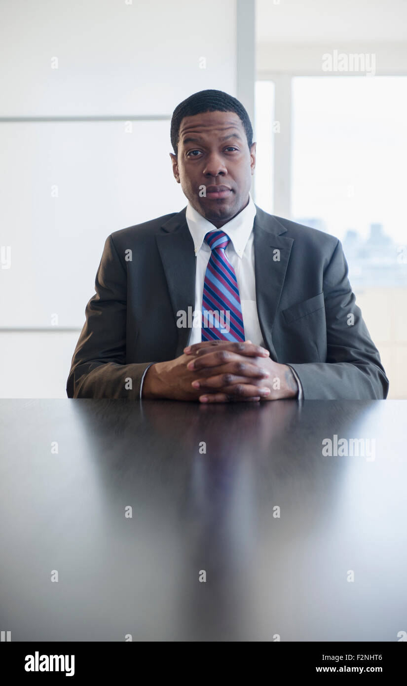 Businessman sitting at conference table in meeting Stock Photo - Alamy