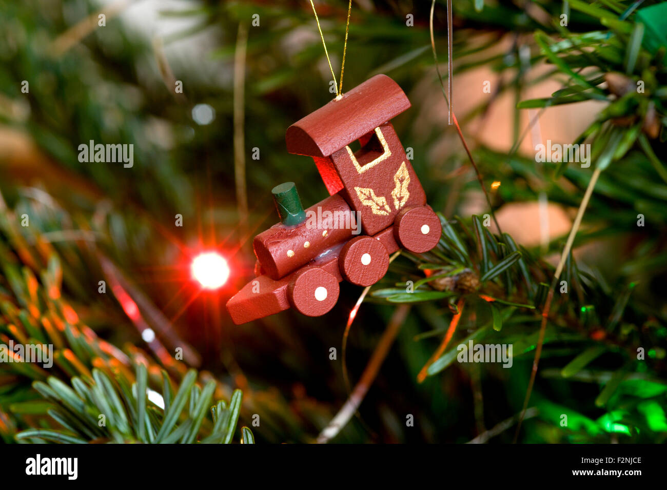 a small bright red steam engine shaped wooden christmas tree decoration ...