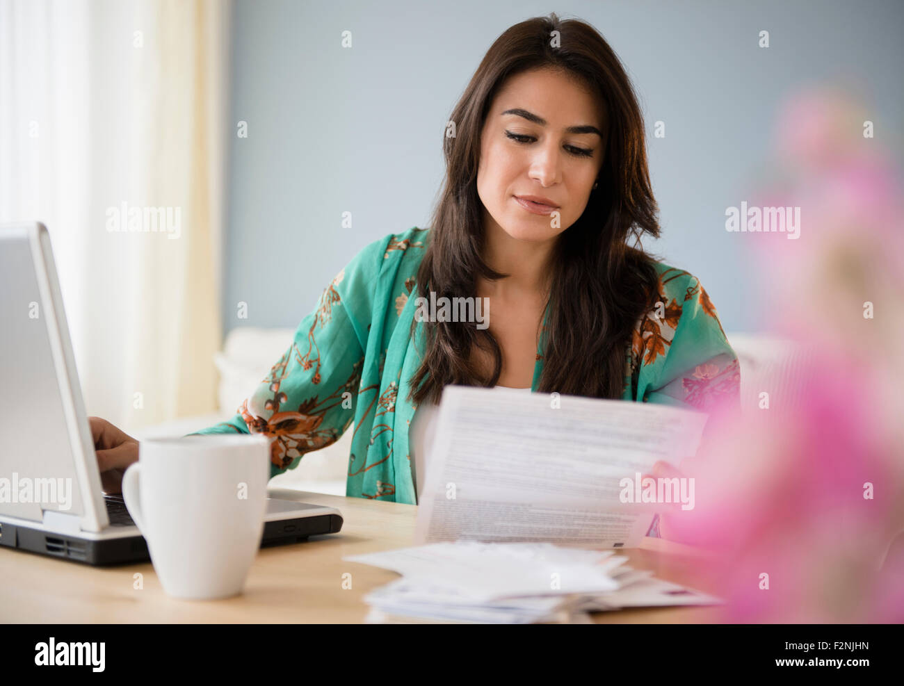 Woman paying bills on laptop Stock Photo - Alamy
