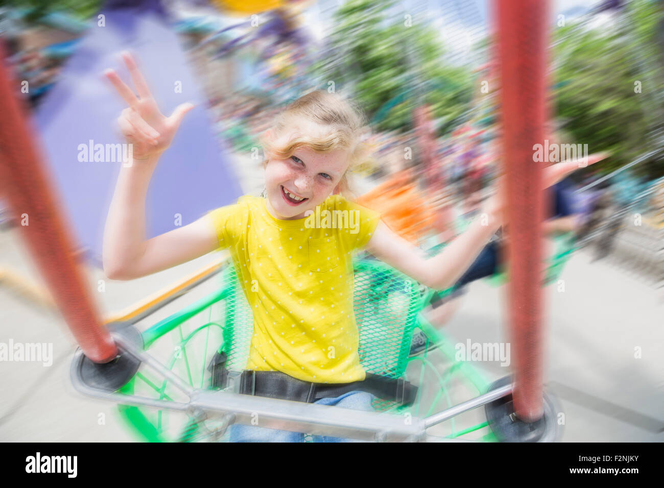 Caucasian girl riding roller coaster in amusement park Stock Photo - Alamy