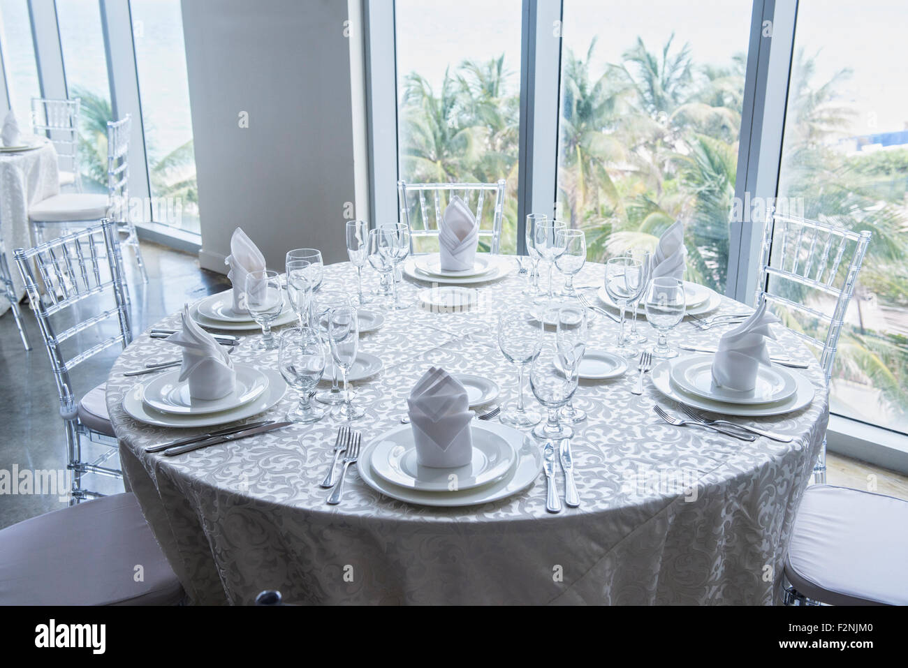 Set table at window in restaurant Stock Photo - Alamy