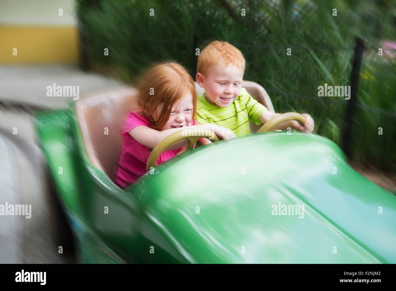 Caucasian children on ride in amusement park Stock Photo - Alamy