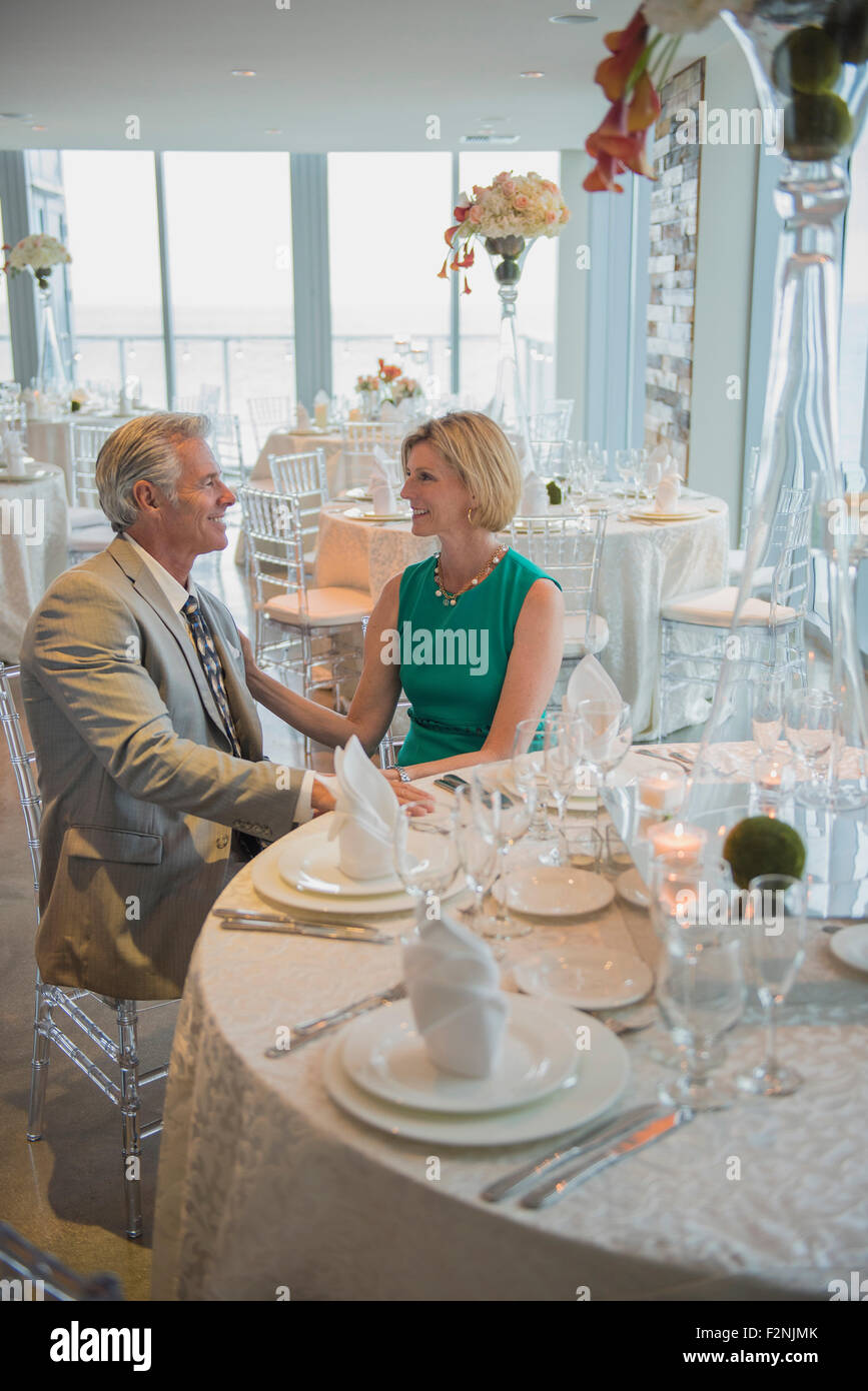 Caucasian couple talking in empty restaurant Stock Photo - Alamy