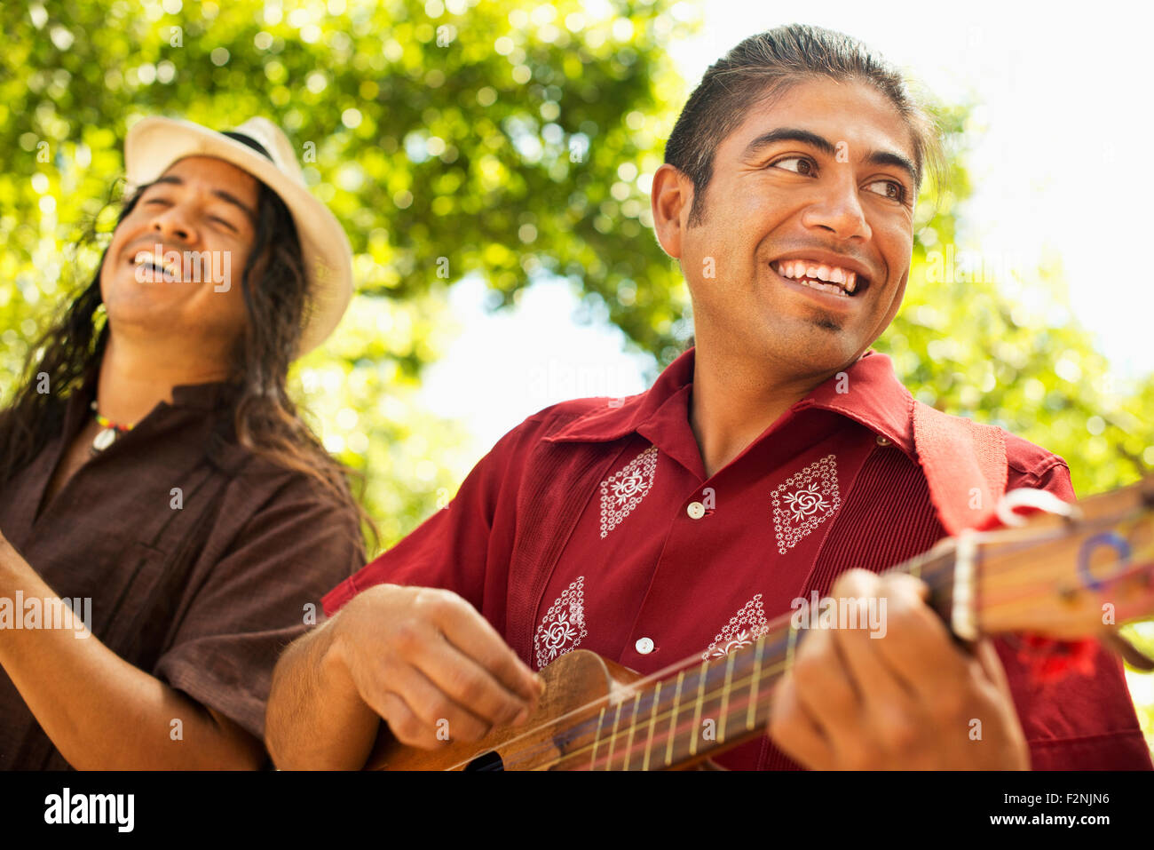Musicians performing in park Stock Photo - Alamy