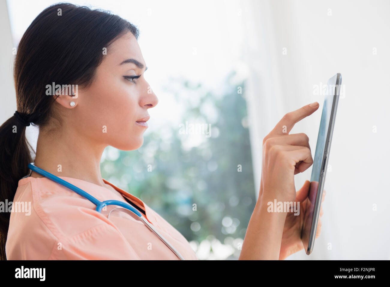 Nurse using digital tablet in hospital Stock Photo - Alamy