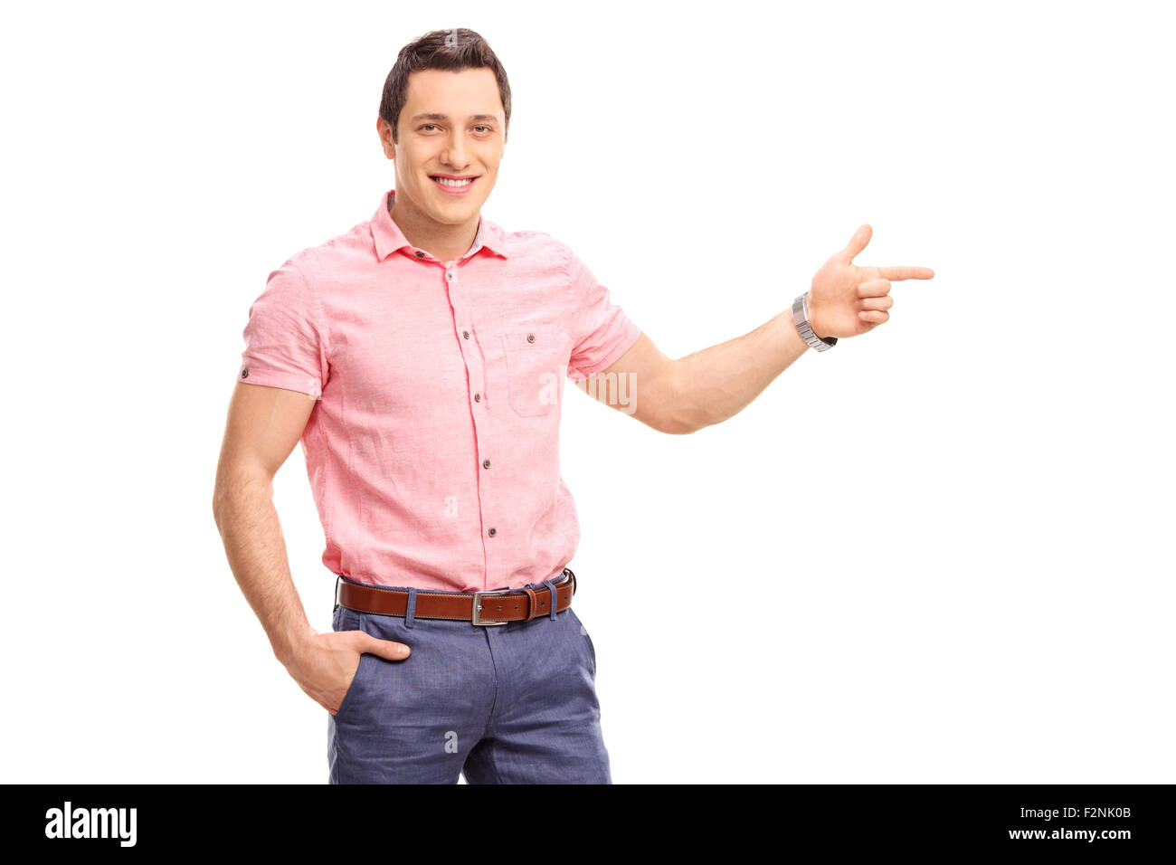 Casual young man pointing right with his finger and looking at the ...