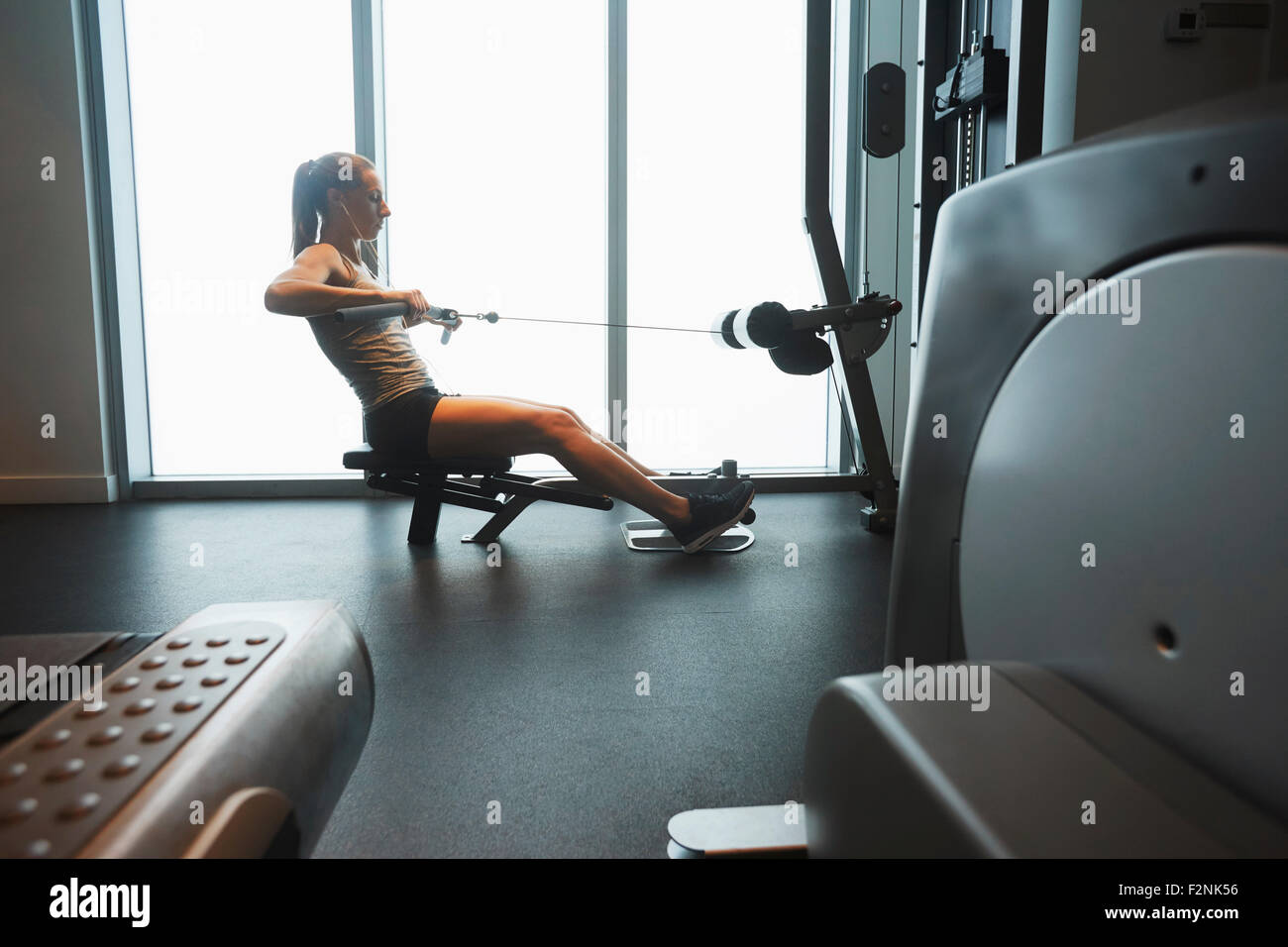 Fit woman using exercise machine hi-res stock photography and images ...