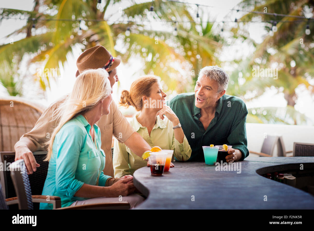 Couples having cocktails at patio bar Stock Photo - Alamy