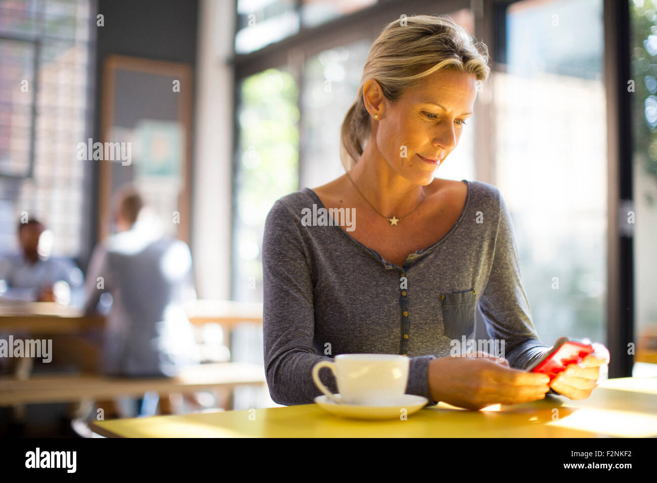 Woman cafe cell hi-res stock photography and images - Alamy