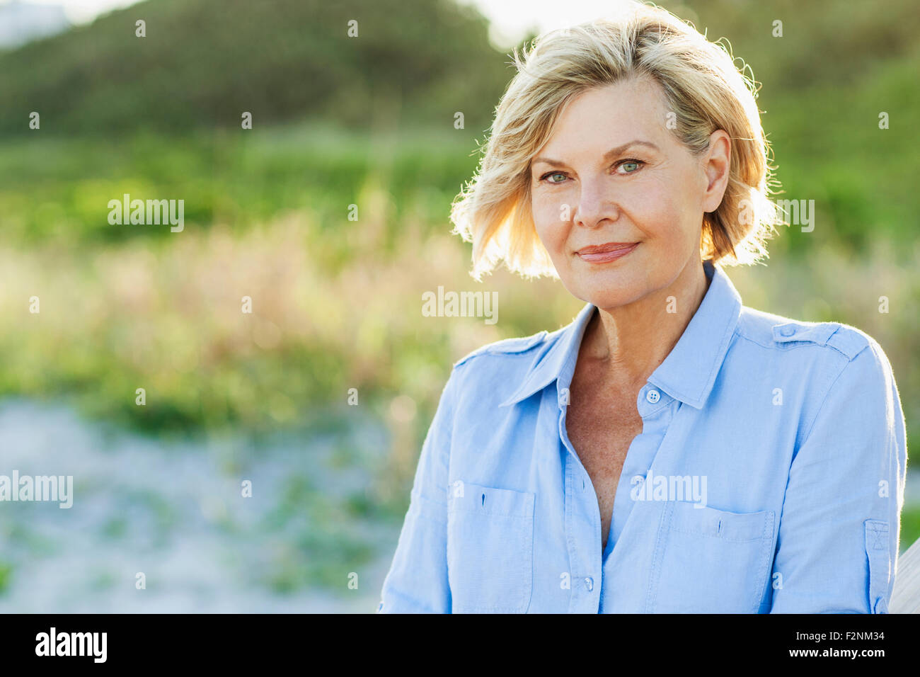 Caucasian woman smiling on beach Stock Photo - Alamy