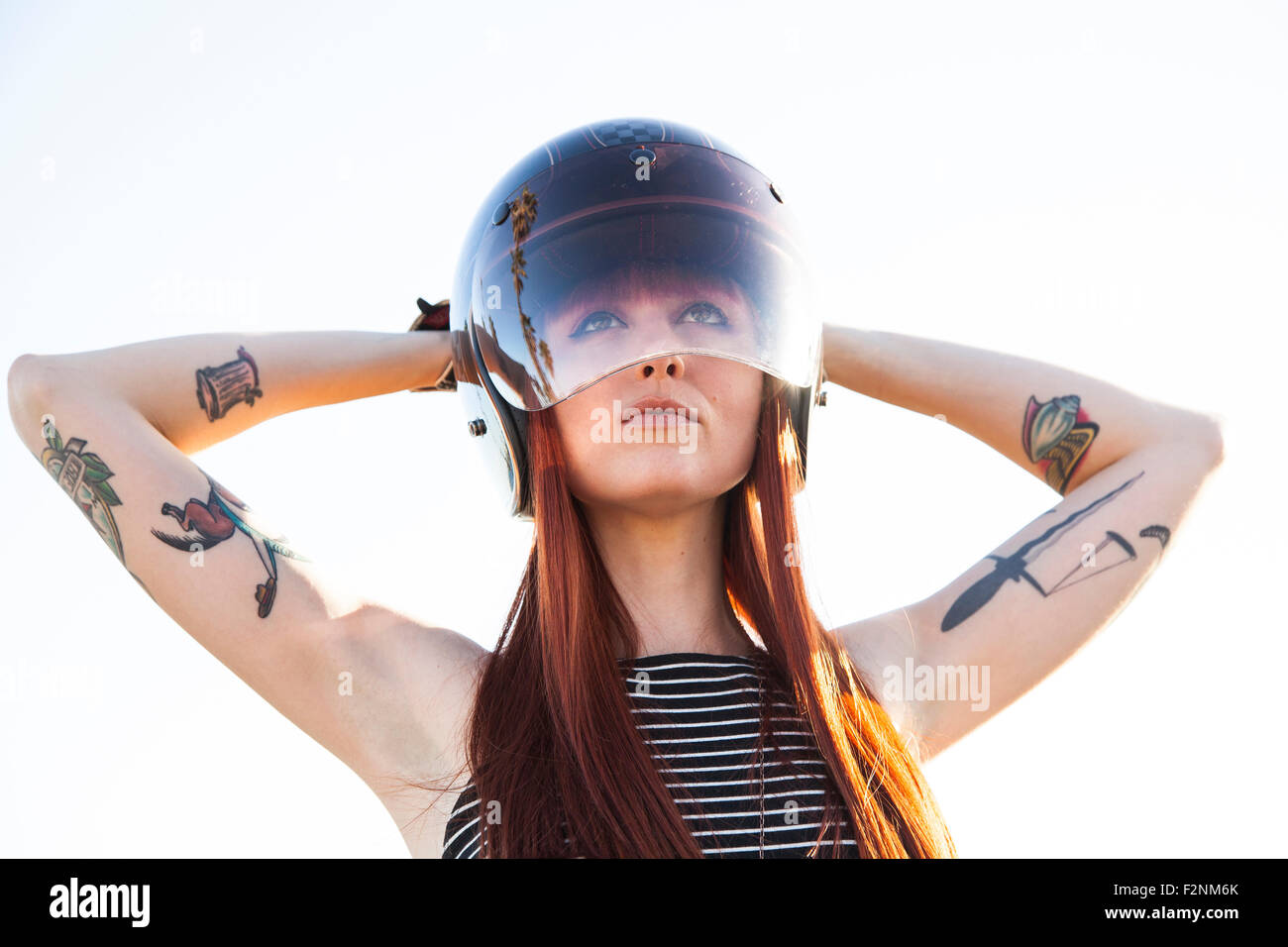 Woman with red helmet hi-res stock photography and images - Alamy