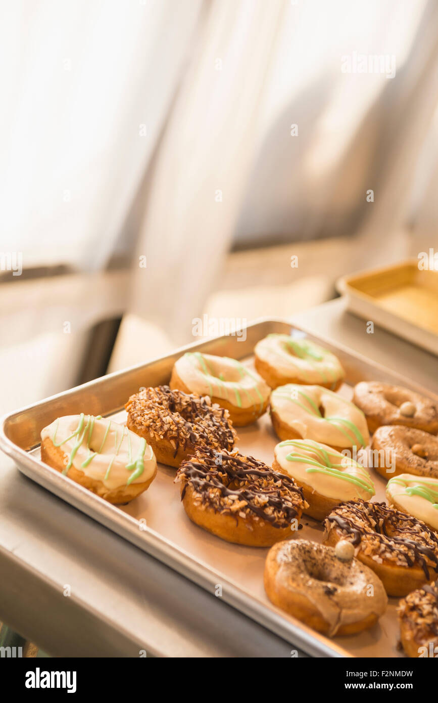 Close up of donuts for sale in bakery Stock Photo - Alamy