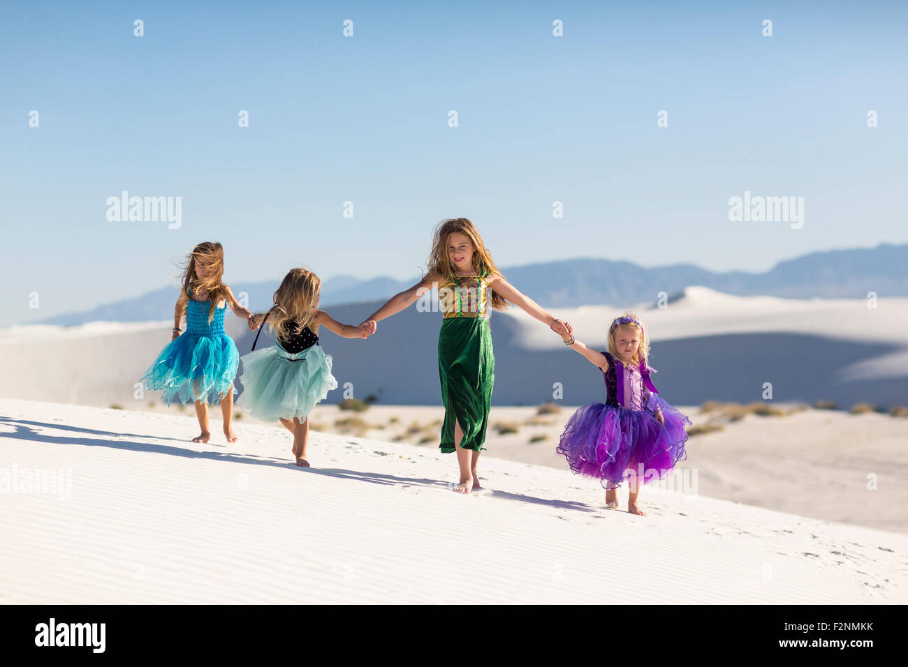 Girls walking on desert sand dunes Stock Photo - Alamy