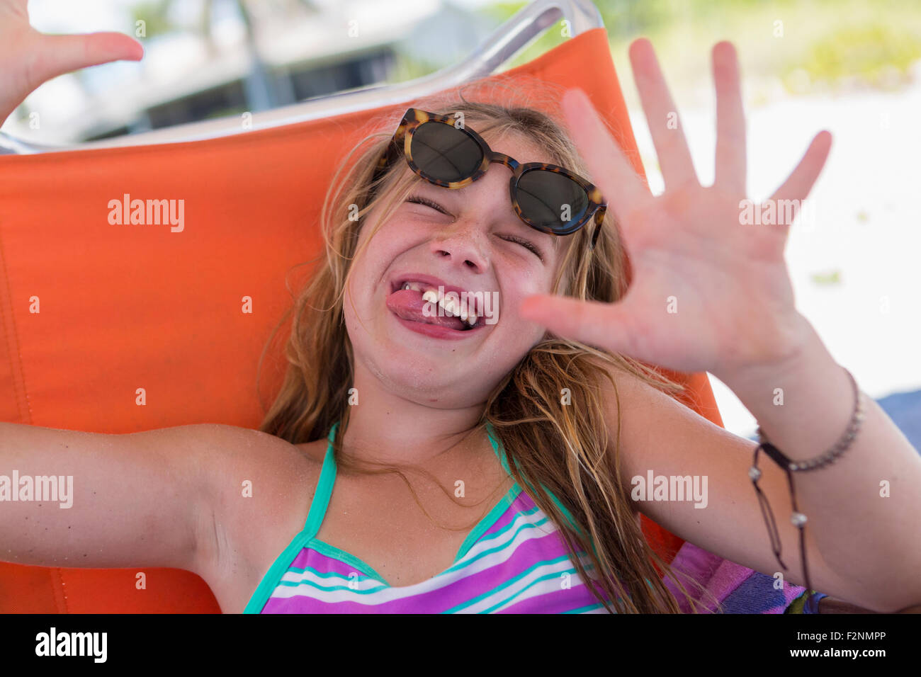 Caucasian girl making a face on beach Stock Photo - Alamy