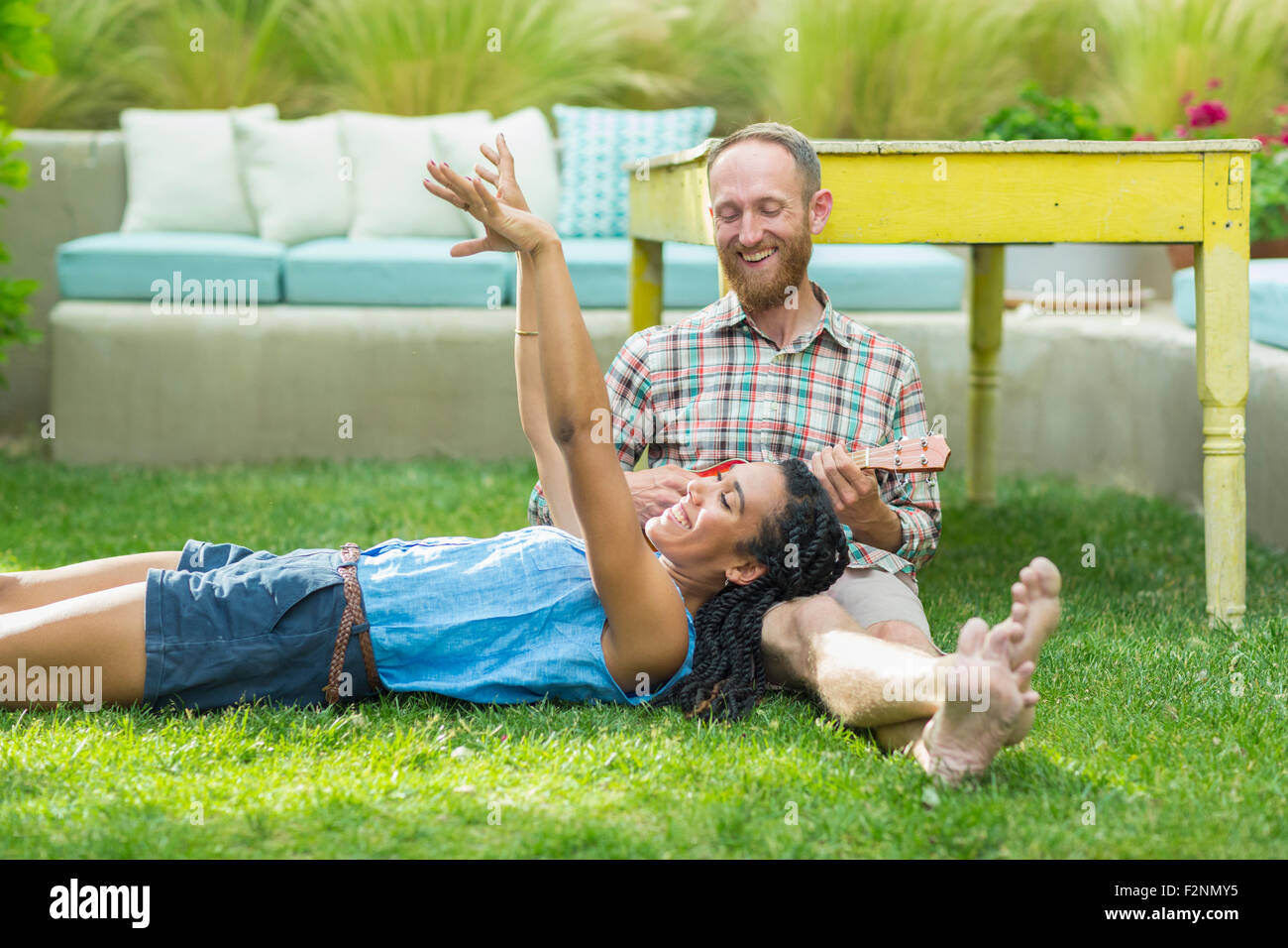 Couple relaxing in backyard Stock Photo - Alamy