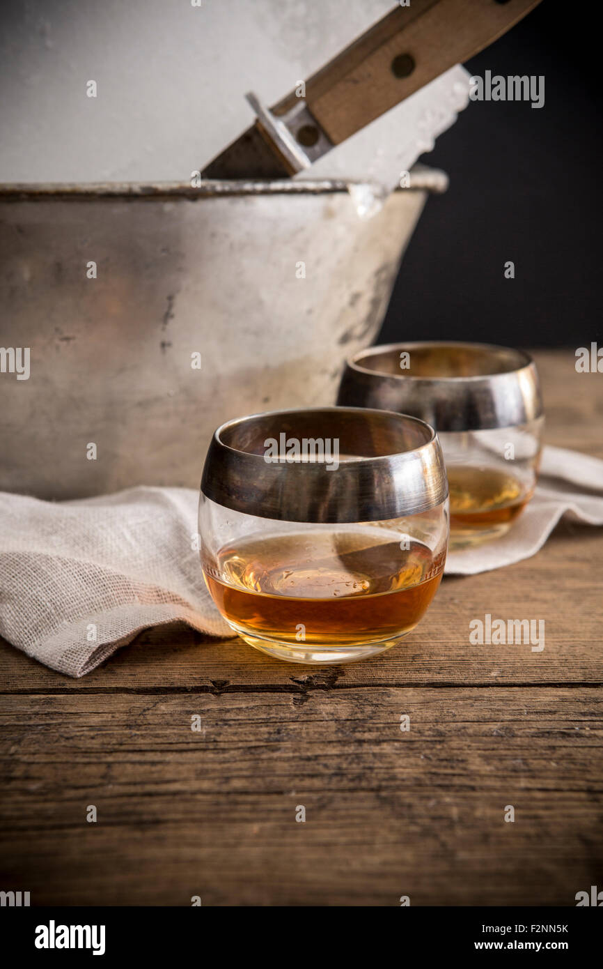 Cocktail glasses and ice block on table Stock Photo - Alamy