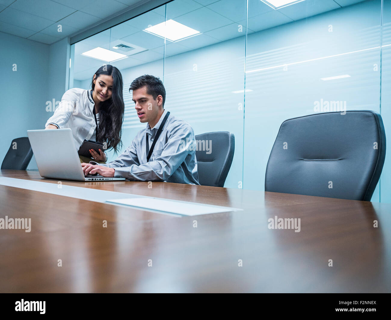 Business people using laptop in conference room Stock Photo - Alamy