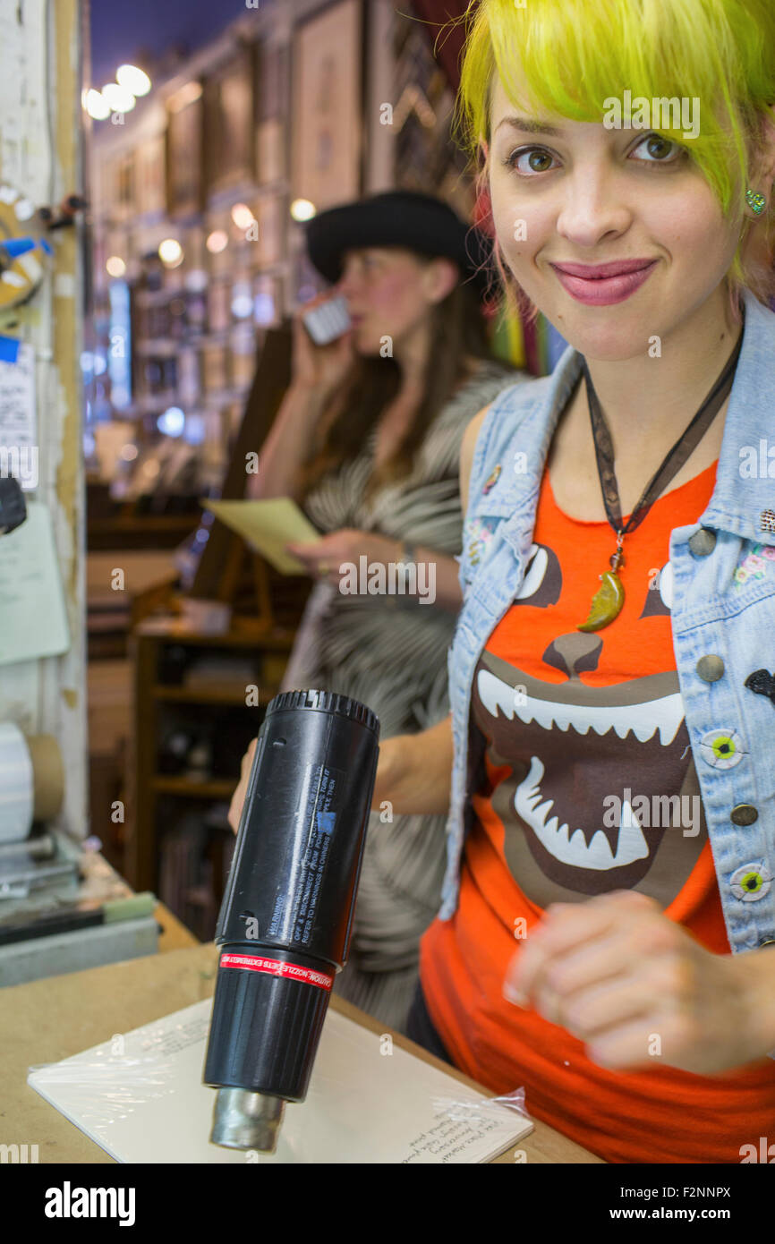 Caucasian artist using heat gun in workshop Stock Photo - Alamy