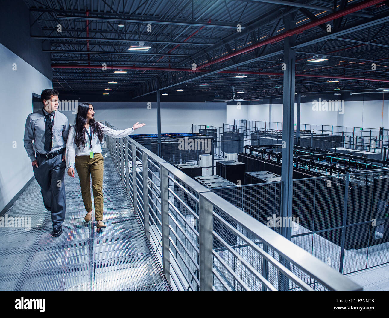 Businesswoman showing colleague server room from balcony Stock Photo ...