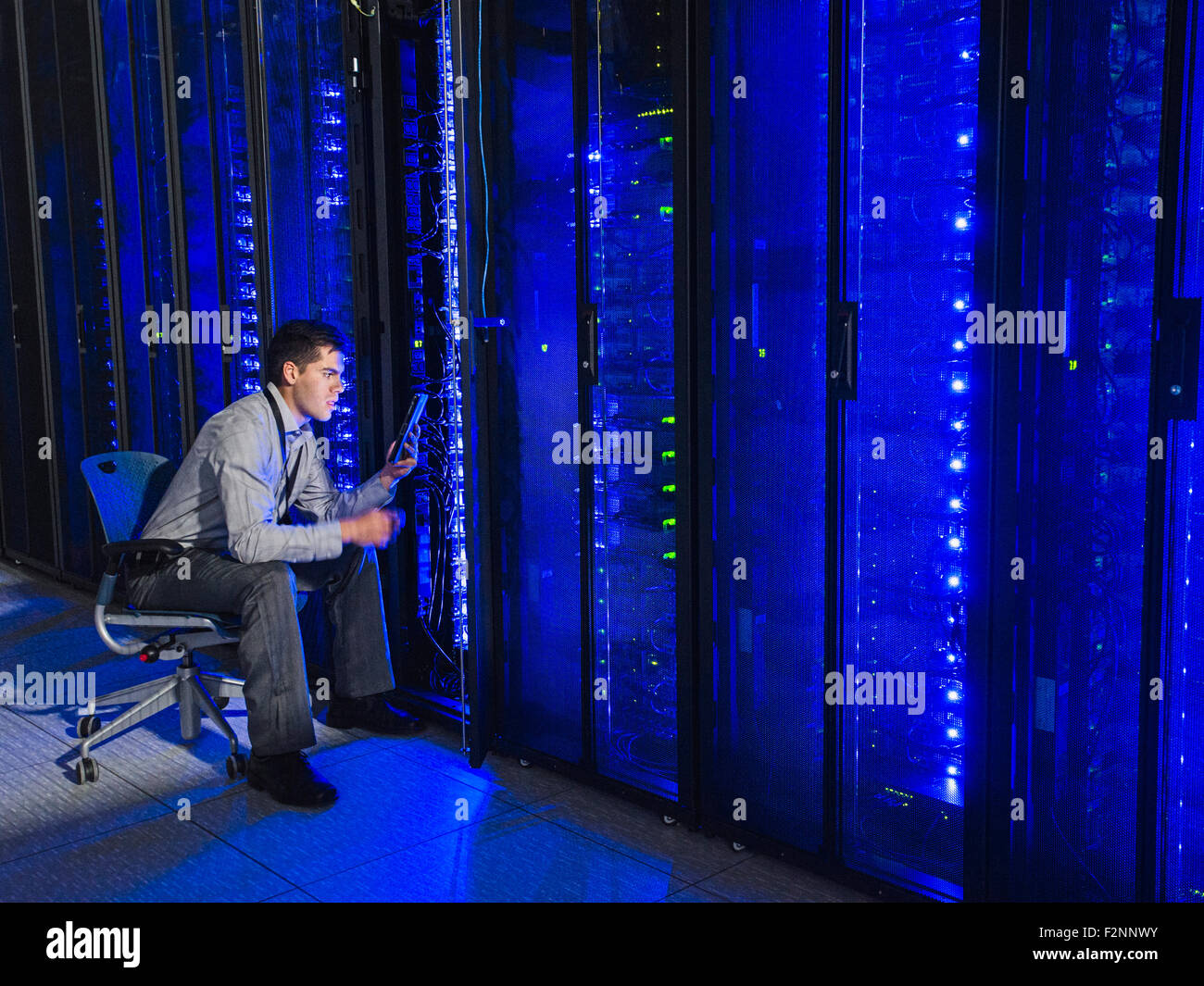 Hispanic technician working in server room Stock Photo - Alamy