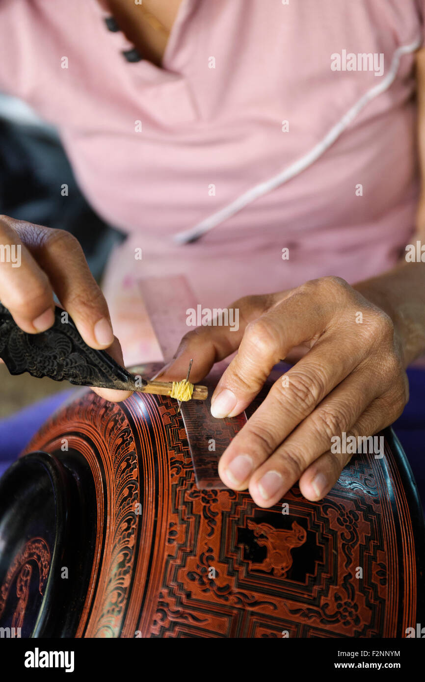 Asian artisan carving traditional design in workshop Stock Photo - Alamy