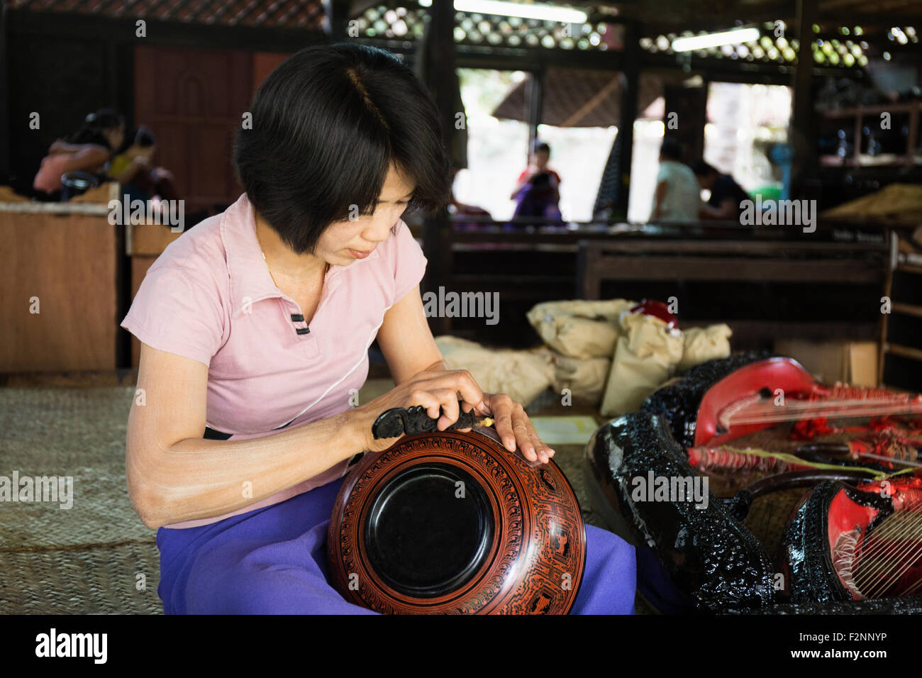 Asian artisan carving traditional design in workshop Stock Photo - Alamy
