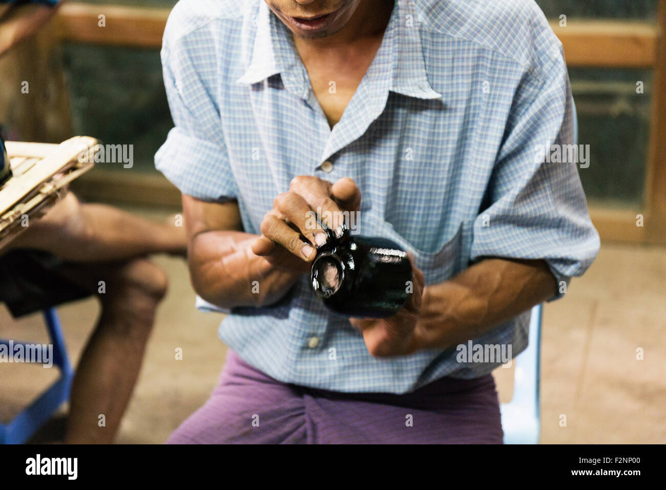 Asian artisan painting traditional design in workshop Stock Photo - Alamy