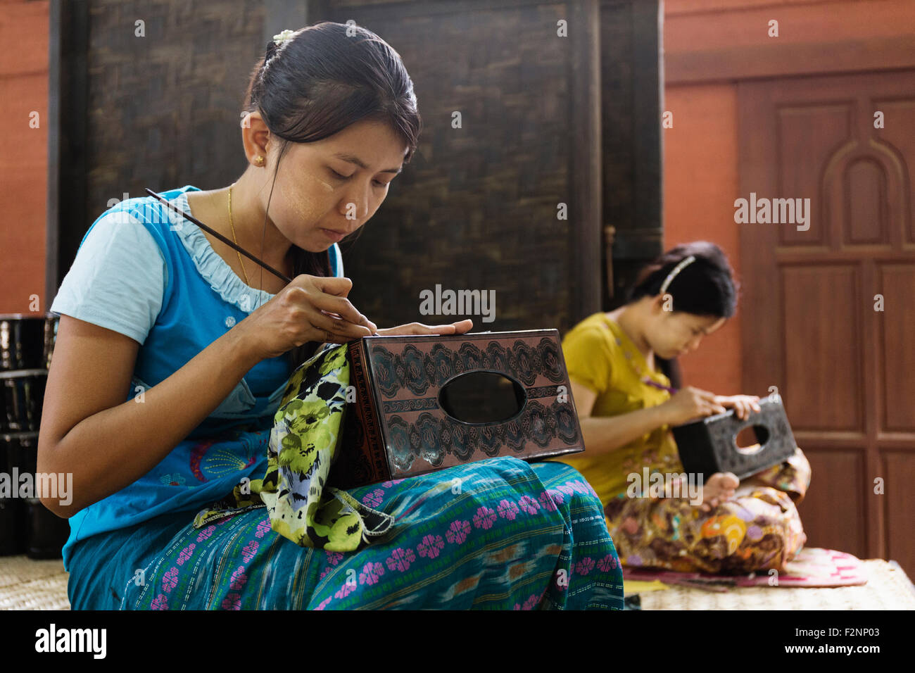 Asian artisans carving traditional design in workshop Stock Photo - Alamy