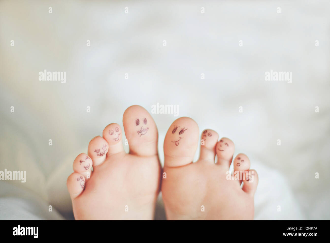 Toes of Caucasian girl with smiley face drawings Stock Photo - Alamy